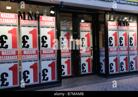 Clearance sale posters in shop window Stock Photo - Alamy