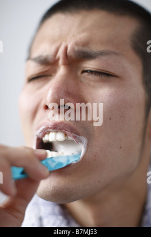 Japanese man brushing teeth Stock Photo - Alamy