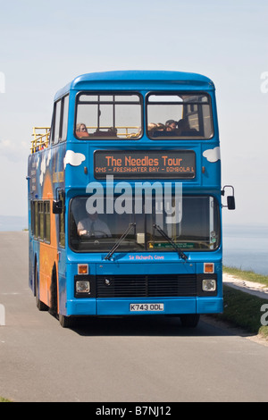 Isle of Wight open top tour bus on road overlooking Alum Bay Stock ...