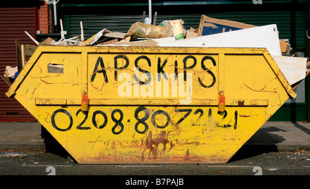 Gv of a yellow skip full of rubbish Stock Photo - Alamy