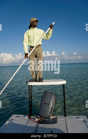 Bonefishing guide Shawn Leadon fishing for bonefish in shallow waters ...