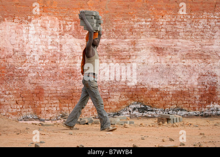 Very young boy carrying bricks on his head Jahukel brick factory Nepal ...
