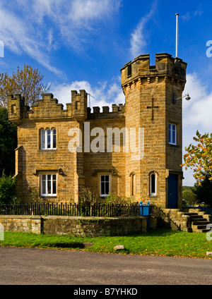 Castellated gate house in Edensor model village near Bakewell in the ...
