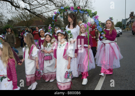 London May Queen and retinue in procession through a suburban High ...