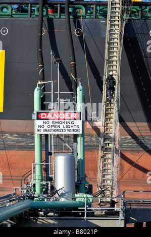 Fuel oil tanker offloading oil with a hose handling crane Stock Photo ...