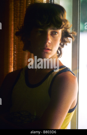 Sad boy next to a window Stock Photo - Alamy