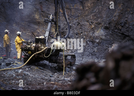 Surface pit gold mining, drilling holes for charges before blast with ...
