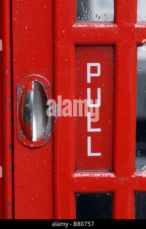 Pull handle on traditional red telephone box Stock Photo - Alamy