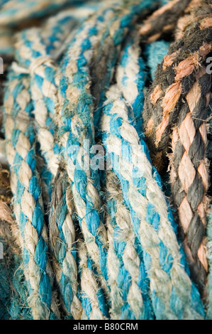 A close-up of a tangled pile of black electrical cables. Rolls of ...