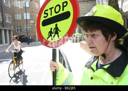A LOLLIPOP LADY AT A SCHOOL CROSSING Stock Photo - Alamy
