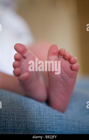 Close up of feet of a girl in red sneakers rides on blue plastic penny ...