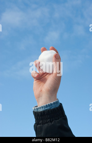 Hand holding snowball, ready to throw Stock Photo - Alamy