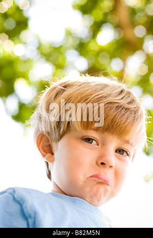 Silly young child blond boy gruesomely grimacing for camera Stock Photo ...