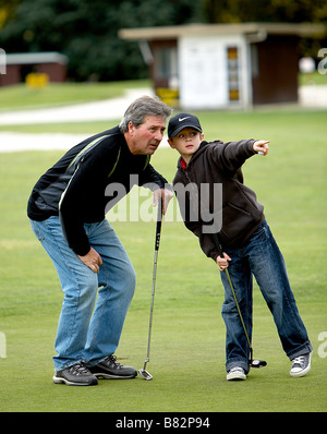 Grandfather and young boy enjoy a lesson in nature on a sunny spring ...