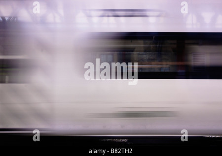 Speeding train going through station (motion blur Stock Photo - Alamy