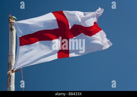 English Flag known as St George's Cross flying with blue sky behind ...