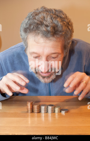 A miserly man counting his money Stock Photo - Alamy