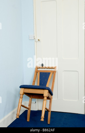 Chair being used to secure a door and stop it being opened Stock Photo ...