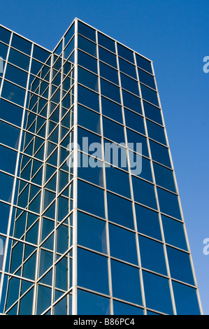 Office building and reflections against blue sky. Business and finance ...