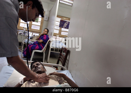 An Indian doctor looks after a patient affected by hiv / aids in a ...