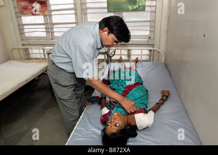 An Indian doctor looks after a patient affected by hiv / aids in a ...