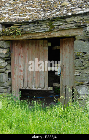 English stone barn with old wooden doors Stock Photo - Alamy