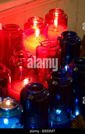 Burning candles in the Catholic Church. Selective focus. Bokeh. Red and ...