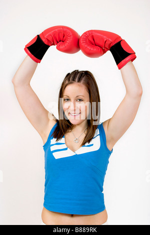 Winner female boxer with her hands raised excited. Isolated on yellow ...