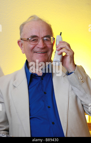 Smile, phone and senior man in home for email notification, text ...
