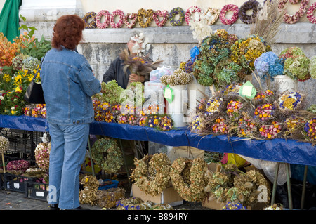 A lady selling flowers at an outdoor Ljubljana flower market Stock ...