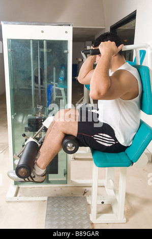 Abdominal crunch machine workout man sit at gym Stock Photo - Alamy