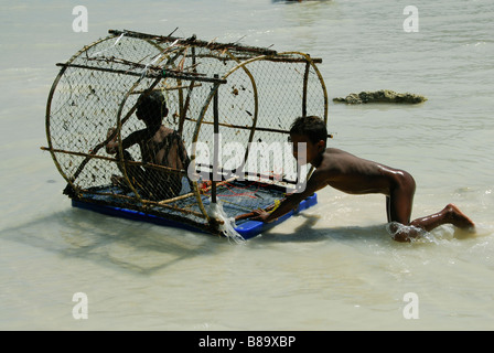 Moken sea gypsy boys enjoy playing by the beach near thier village ...