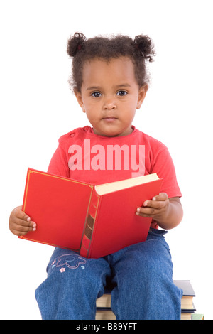 Adorable african baby reading with many pile of books Stock Photo - Alamy