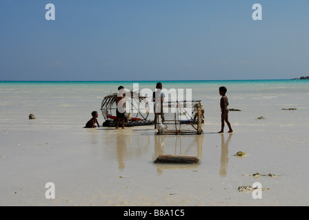 Moken sea gypsy boys enjoy playing with the fish net,Surin Island ...