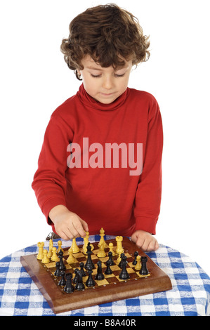 Photo of an adorable boy playing the chess Stock Photo - Alamy