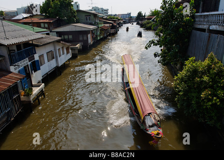 Long tail passenger boats travelling along Khlong Mon river canal ...