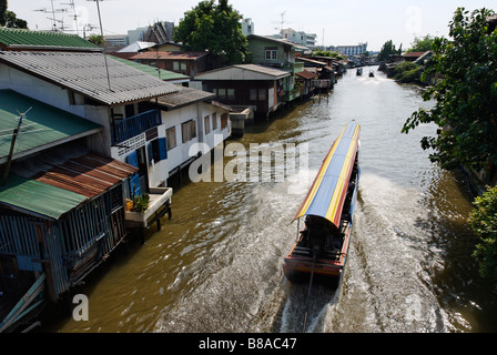 Long tail passenger boats travelling along Khlong Mon river canal ...