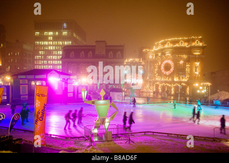 People ice skating at Place Hydro Quebec fronting Capitole Theater ...