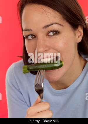 Young Woman Eating Baby Courgette Model Released Stock Photo - Alamy