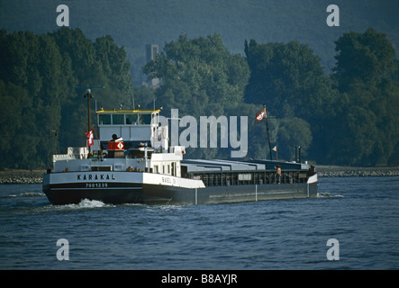 A cargo ship is sailing upstream on the Rhine near Duisburg, followed ...