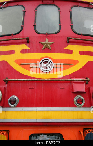 Front cab of yellow and red transport trucks Stock Photo - Alamy