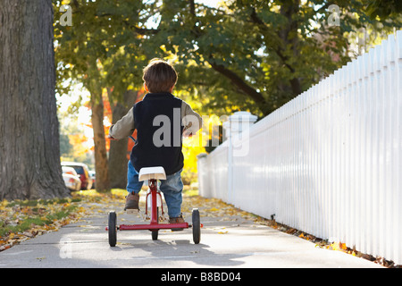 Boy Riding Tricycle Stock Photo - Alamy