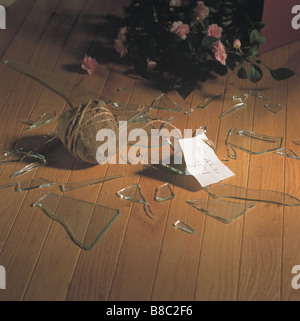 A rock thrown through a window Stock Photo - Alamy