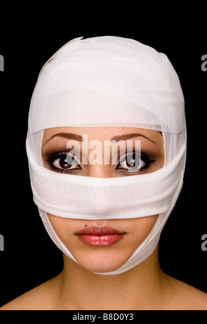Female face bandaged with medical bandages and sunglasses with human ...