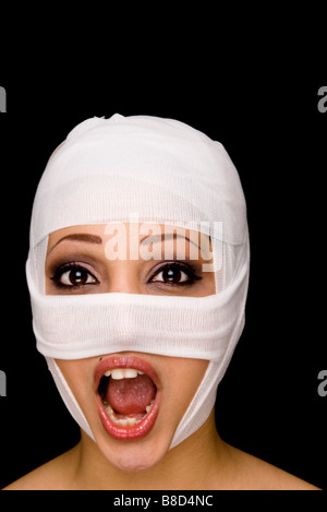 Female face bandaged with medical bandages and sunglasses with human ...