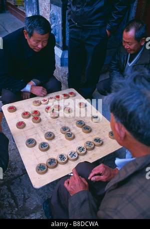 A group of men playing a boardgame in Shenzhen, China Stock Photo - Alamy