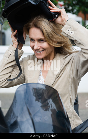 Motorcyclist Removing His Crash Helmet Stock Photo - Alamy