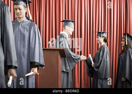 Handshake, graduation diploma and people in success, achievement and ...