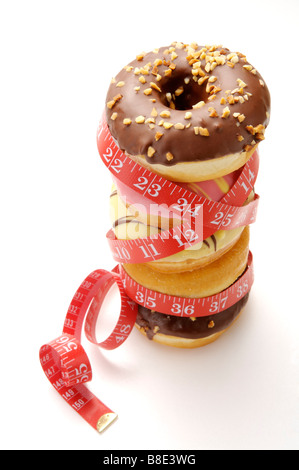 Close up of donut and measuring tape, weight loss and diet concept ...