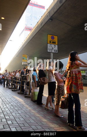 waiting the bus in hong kong Stock Photo - Alamy